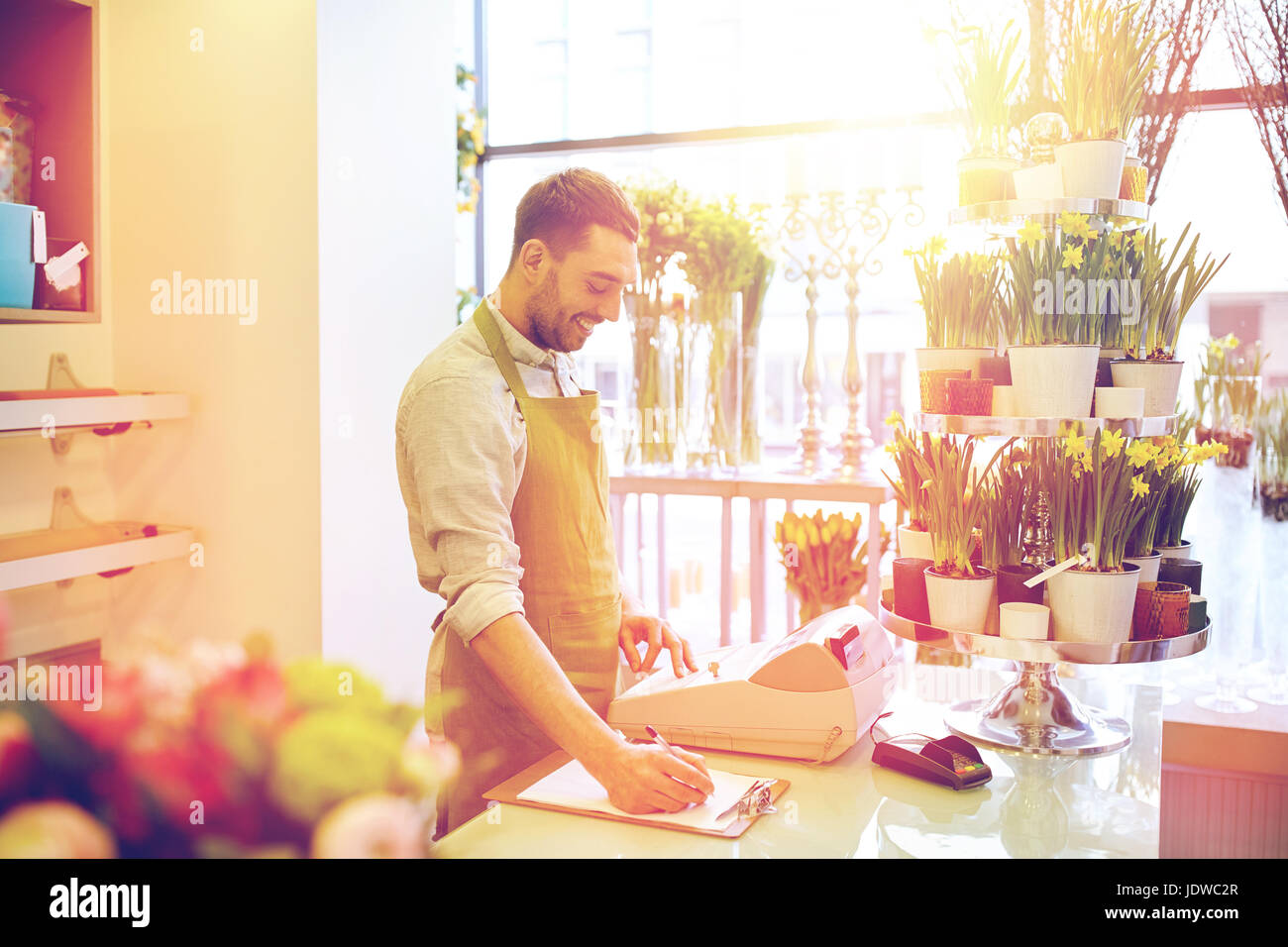 florist man with clipboard at flower shop counter Stock Photo - Alamy