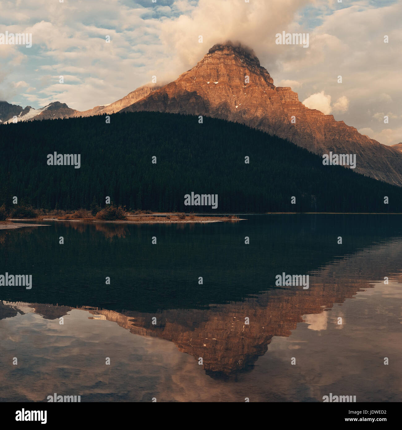 Lake at sunrise with cloud and mountain reflections in Banff National Park Stock Photo - Alamy