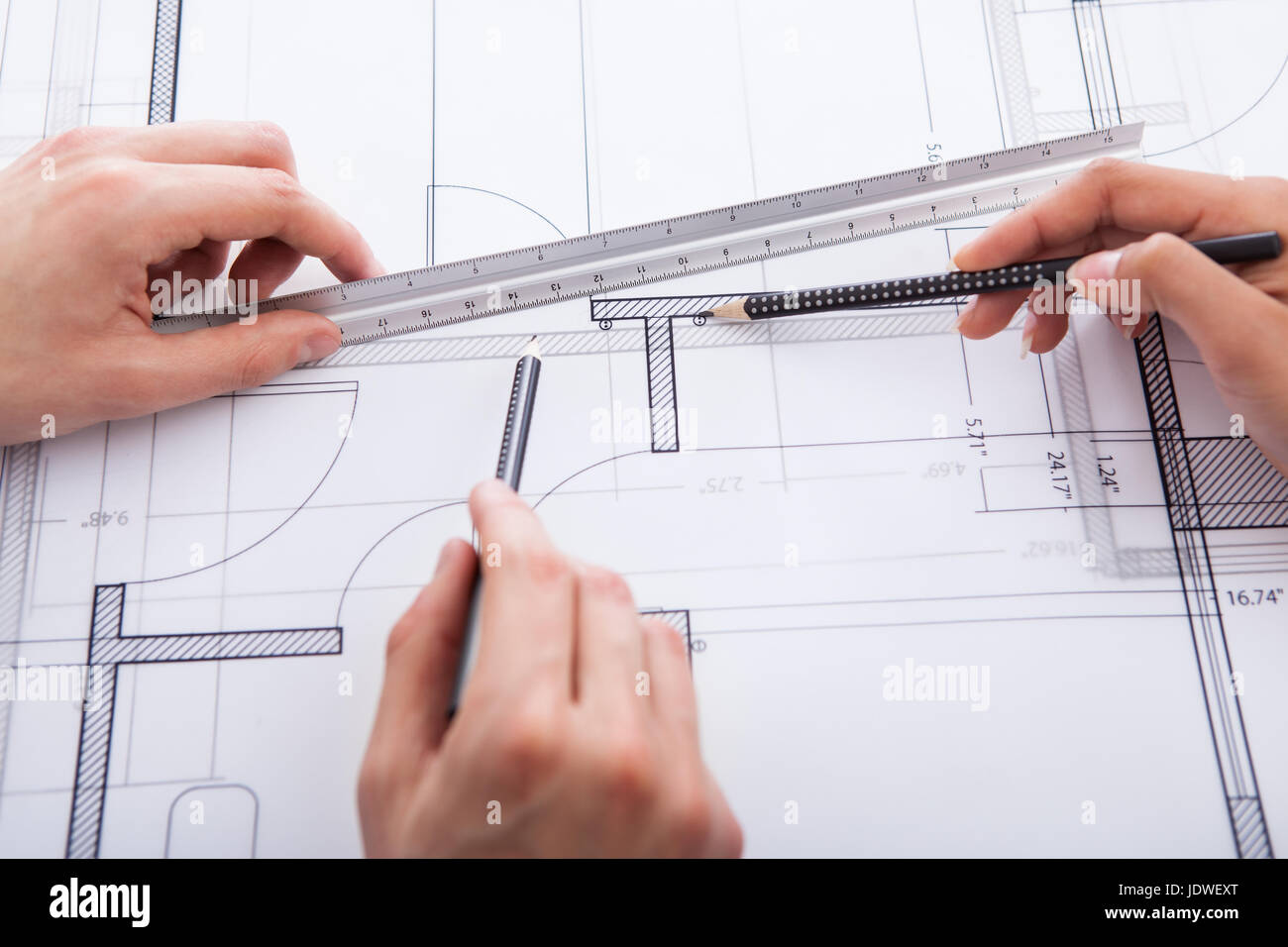 Hands of architects making blueprint at desk in office Stock Photo - Alamy