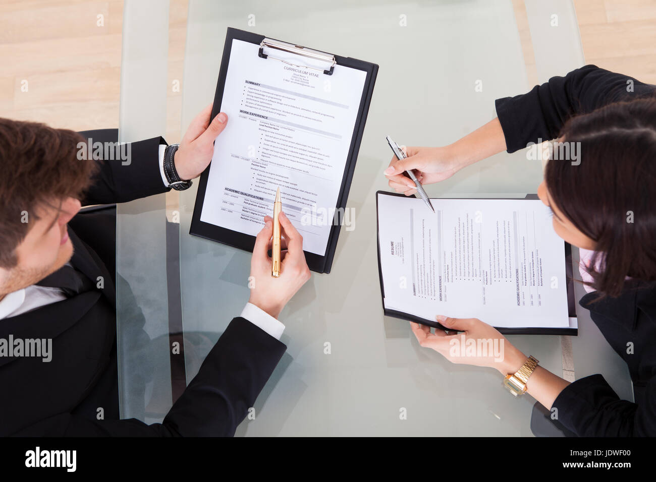 High angle view of business people discussing over documents at desk in ...