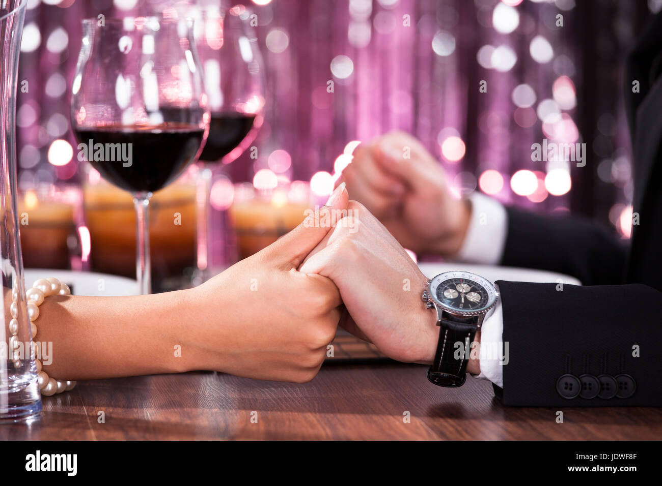 Romantic Couple Holding Each Other's Hand At Dinner In An Restaurant ...