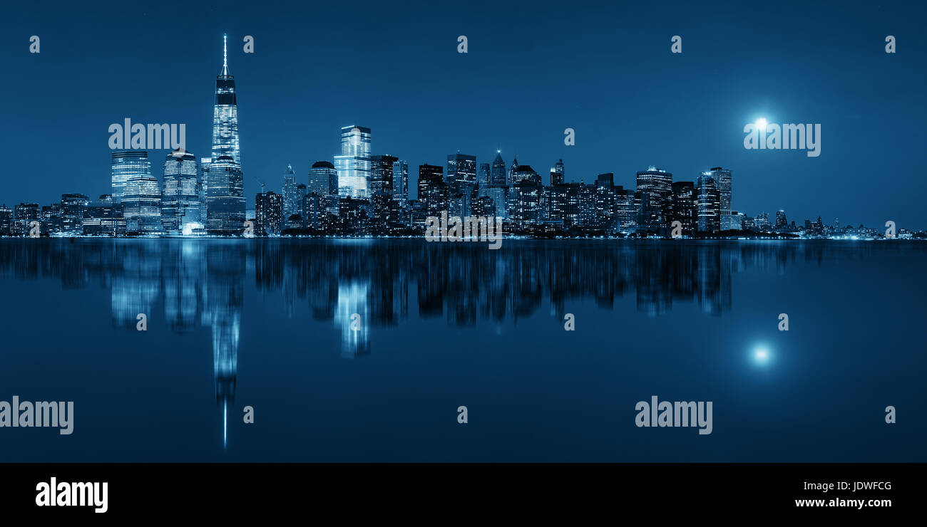 New York City at night with urban architectures reflections Stock Photo ...