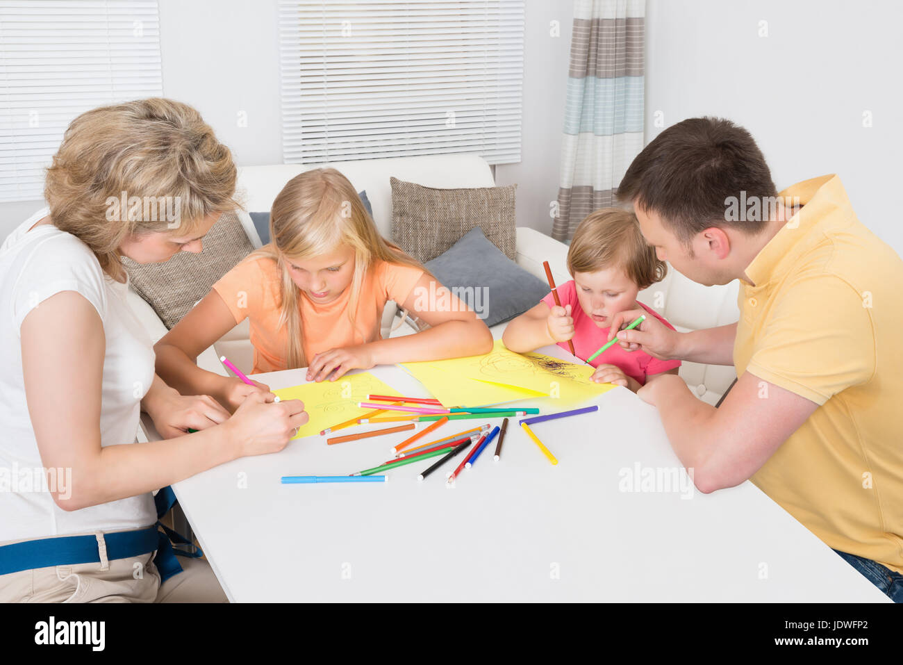 Young Family Drawing Together With Kids At Home Stock Photo - Alamy