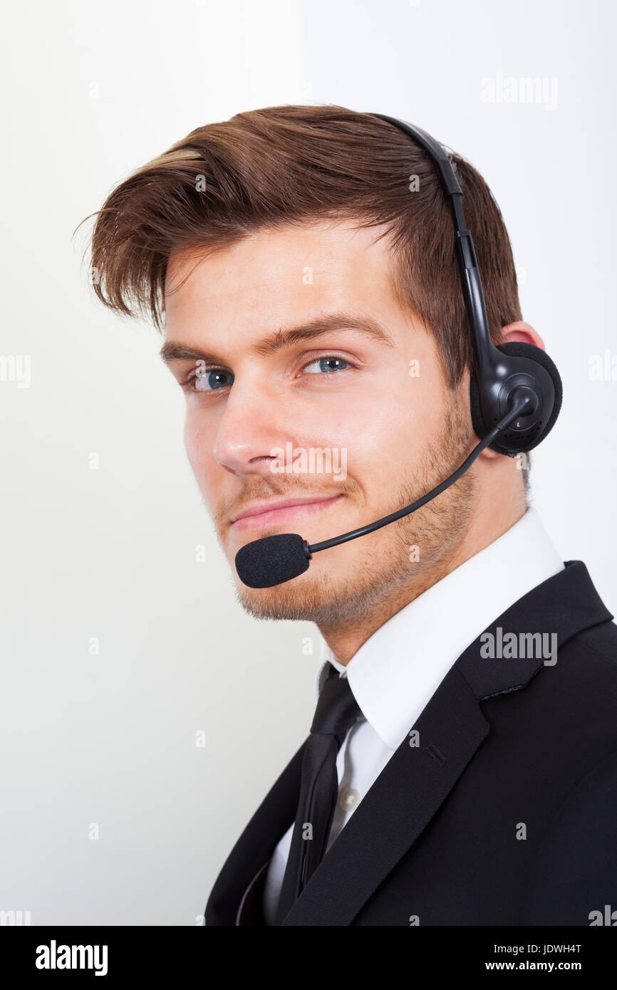 Side view of confident male call center representative wearing headset ...