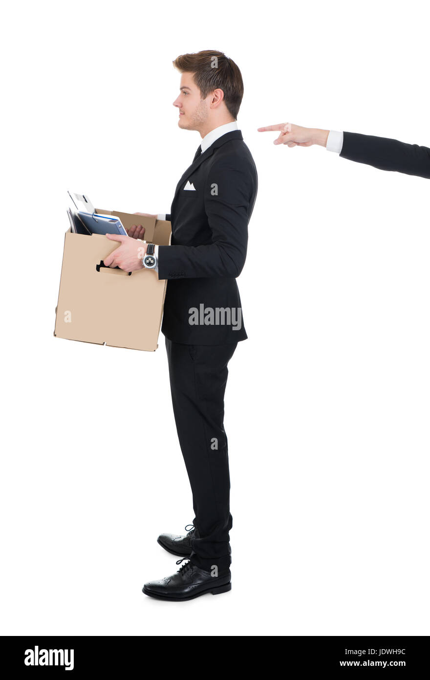 Full length side view of businessman carrying cardboard box with hand ...