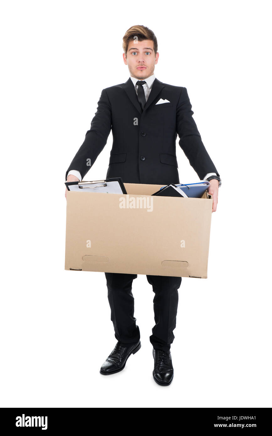 Full length portrait of businessman carrying cardboard box against ...