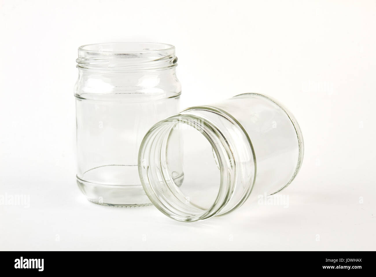 Two glass jars, white background Stock Photo - Alamy