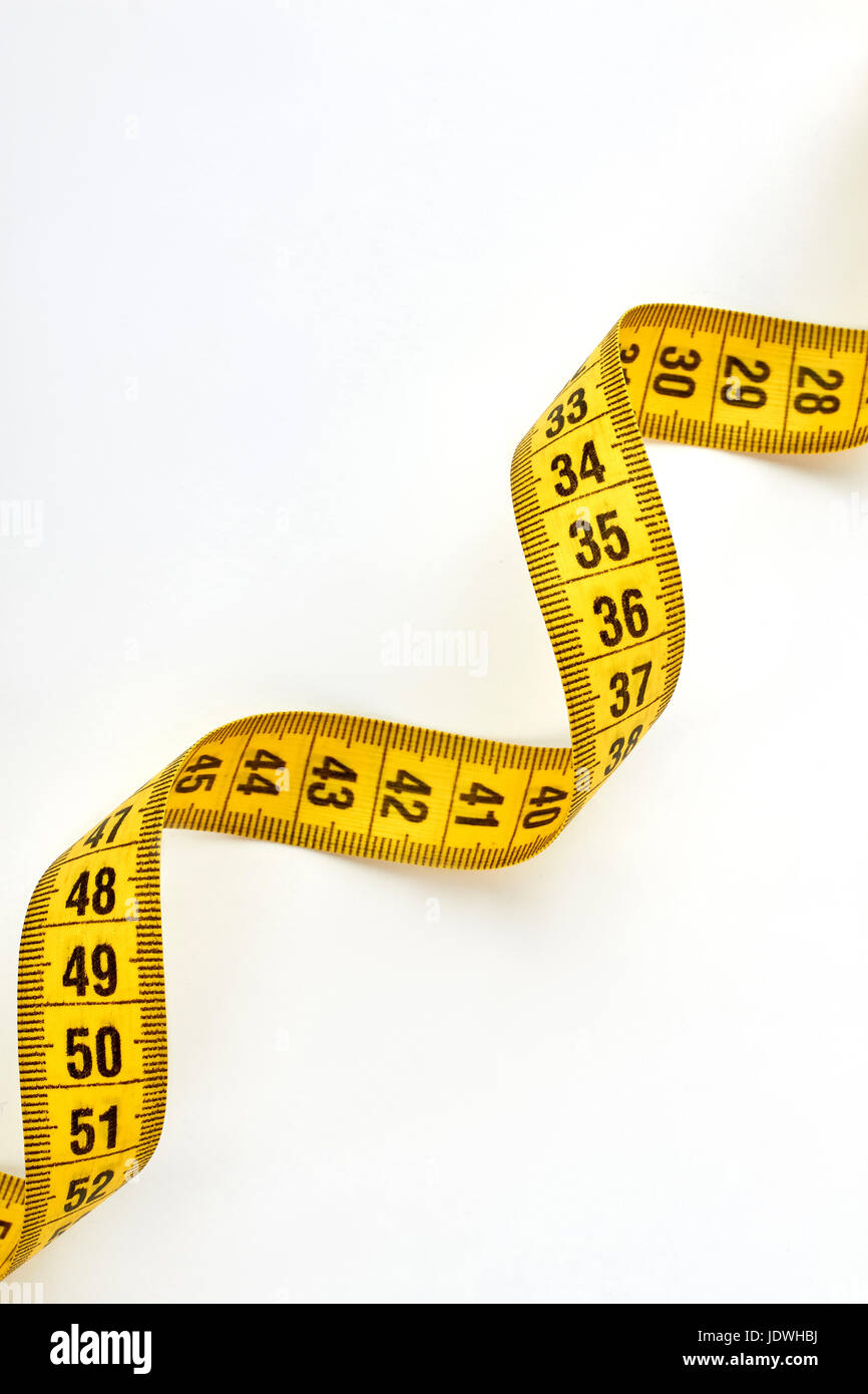 Twisted yellow measuring tape Stock Photo - Alamy