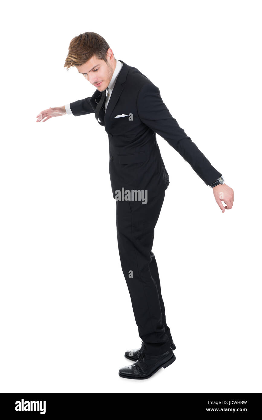 Full length of young businessman about to fall over white background ...