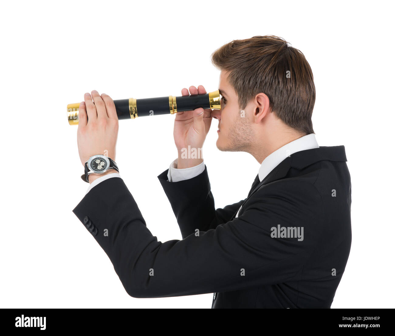 Side view of young businessman looking through handheld telescope ...