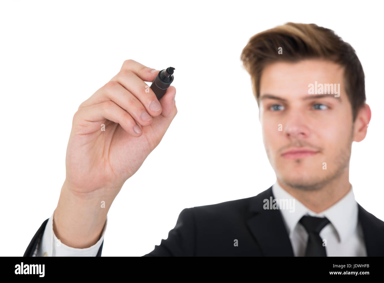 Young businessman writing on transparent screen over white background ...