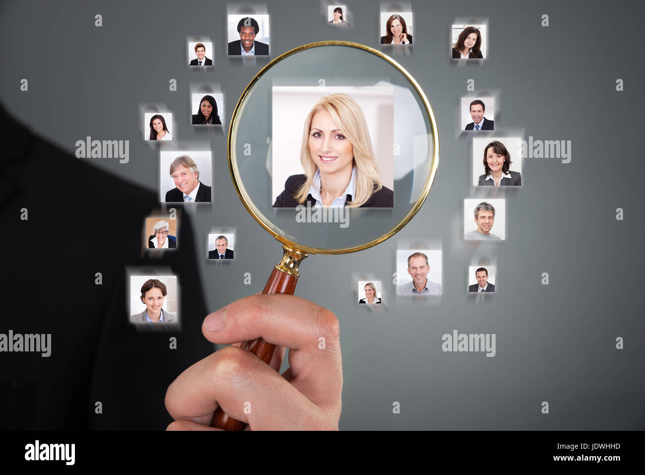 Cropped image of businessman searching candidate with magnifying glass ...