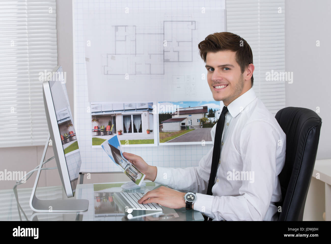 Side view of real estate agent working on computer in office Stock ...