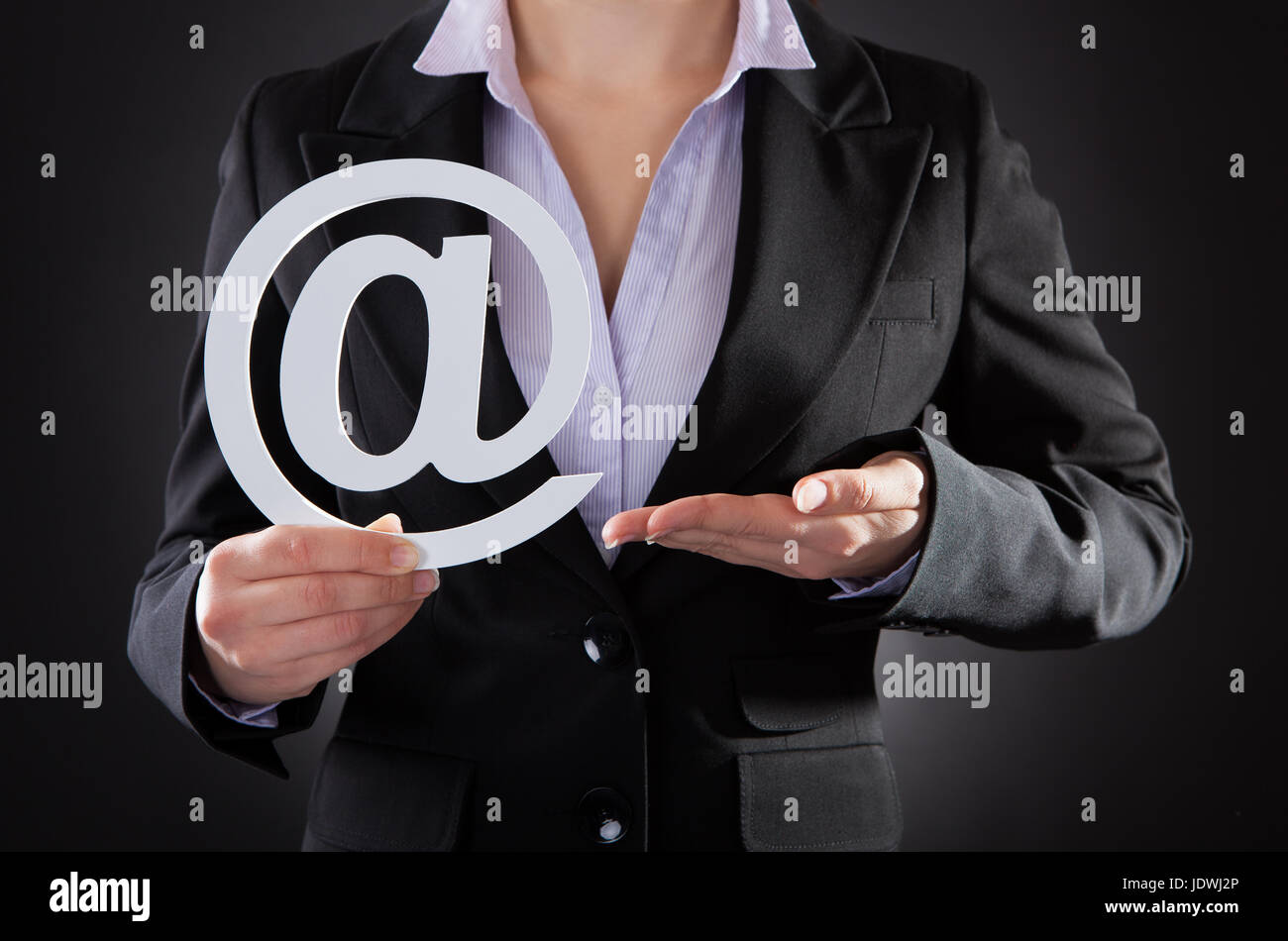 Close-up Of Businessperson Holding Silver Email Symbol Stock Photo - Alamy
