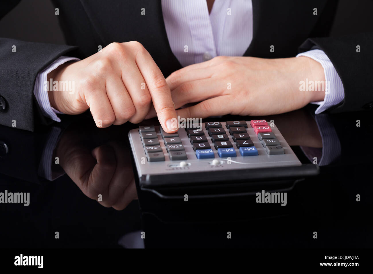 Close-up Photo Of Business Person Using Calculator Stock Photo - Alamy