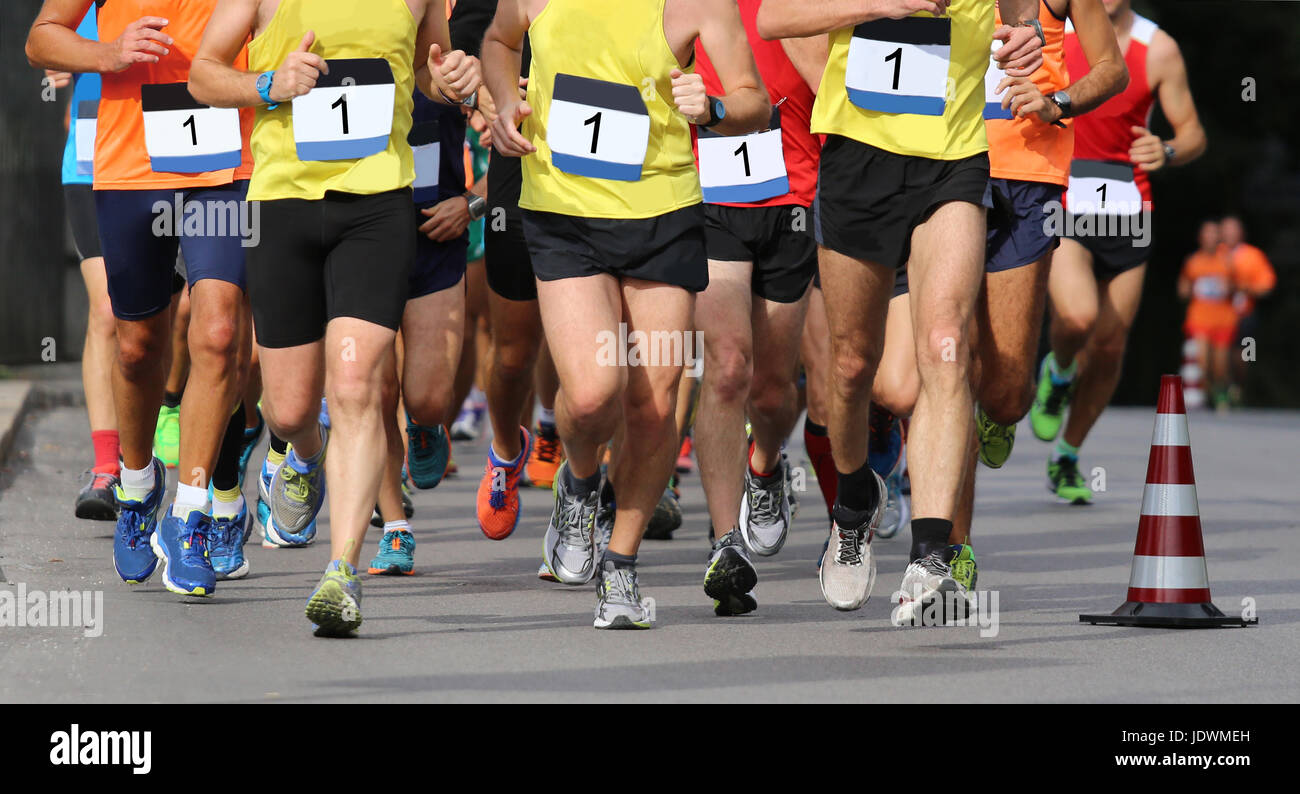 runners during the marathon with the bib number written with 1. All are ...