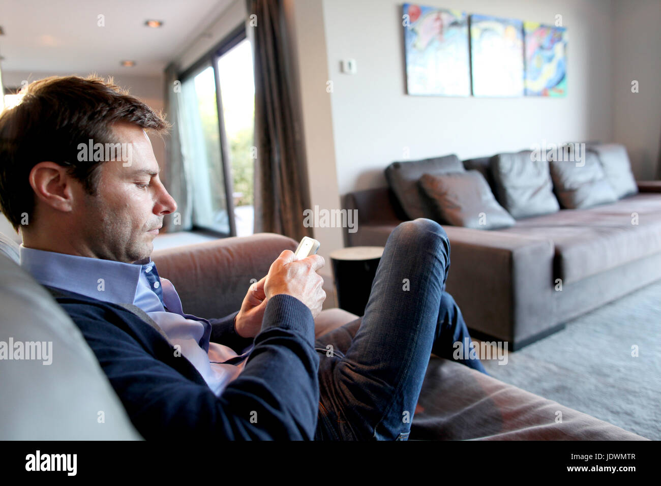 Man sending short message with smartphone Stock Photo - Alamy