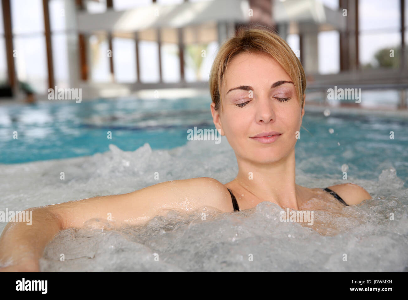 Portrait of woman relaxing in jacuzzi Stock Photo - Alamy