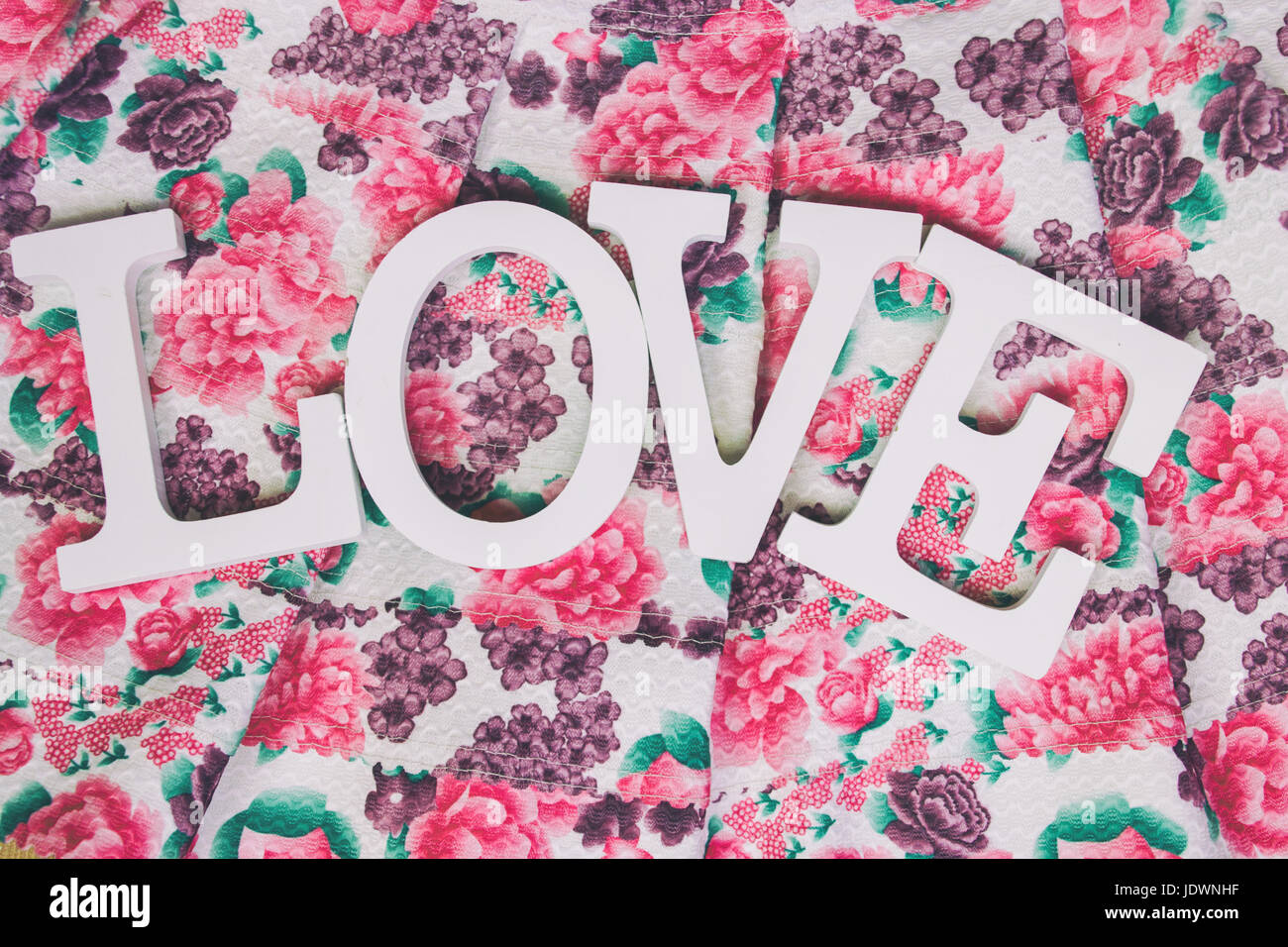 Love word over a flower stamp background Stock Photo - Alamy