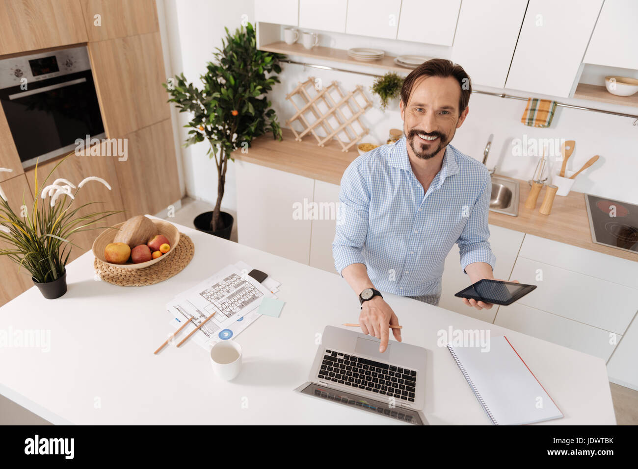 Handsome man posing with his gadgets Stock Photo - Alamy