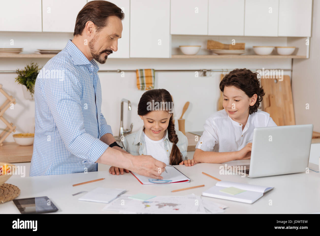 Young father explaining math to his children Stock Photo - Alamy