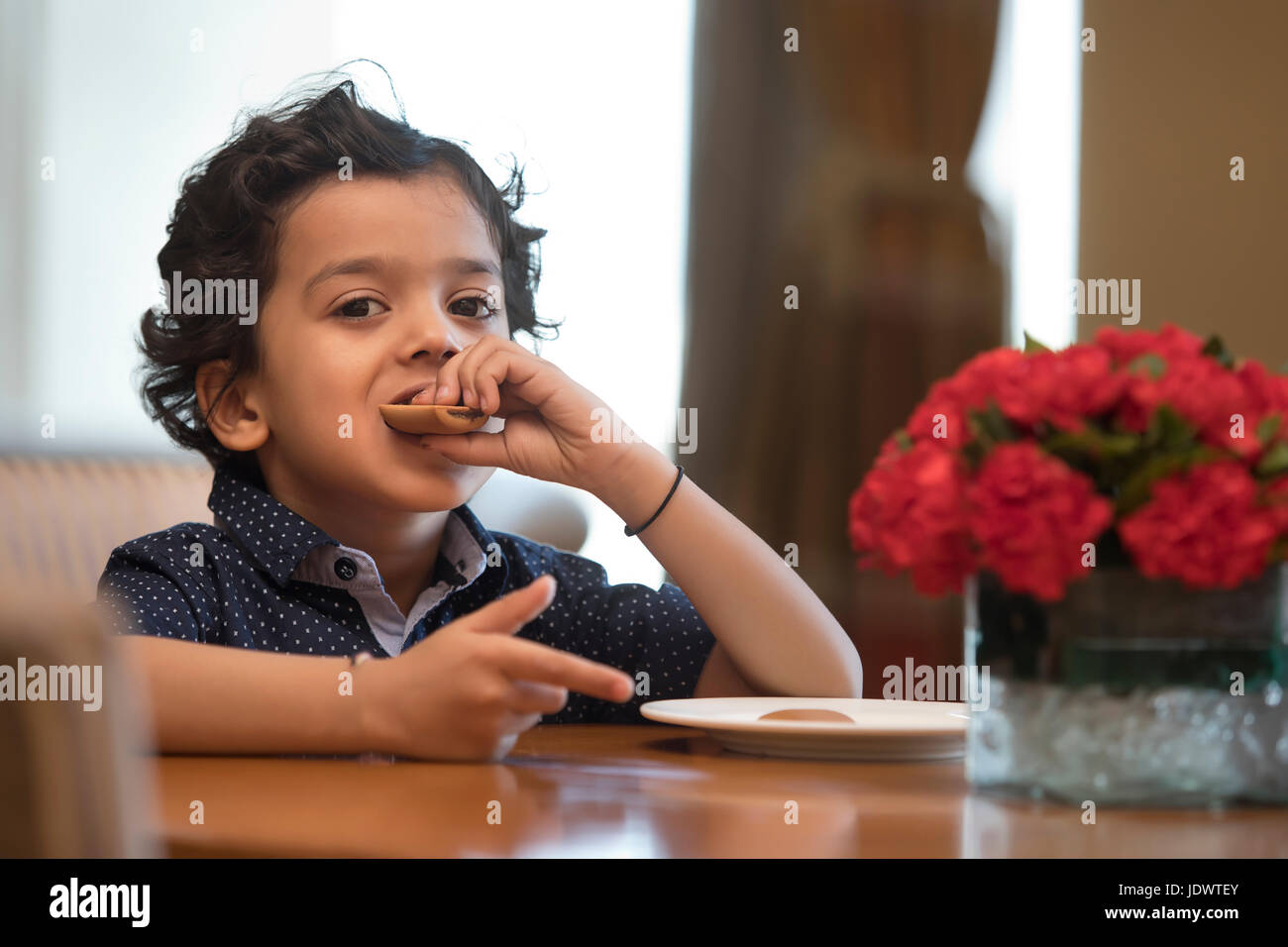Indian boy eating biscuit hi-res stock photography and images - Alamy