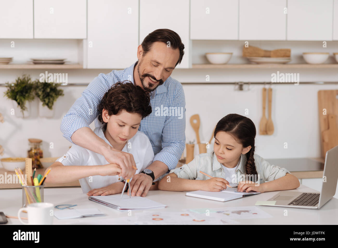 Loving father helping his son to use a compass Stock Photo - Alamy
