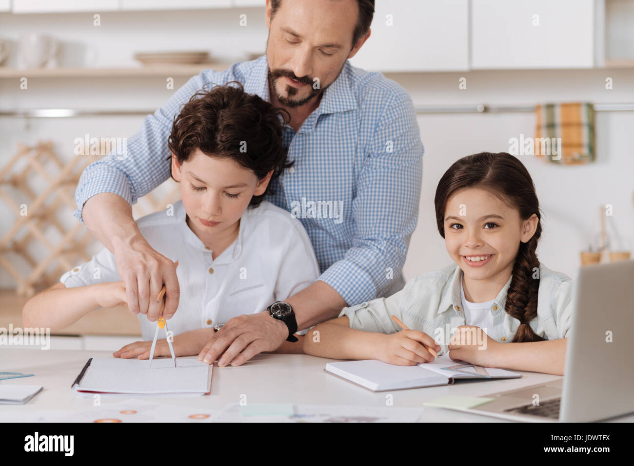 Caring father showing his son how to use a compass Stock Photo - Alamy