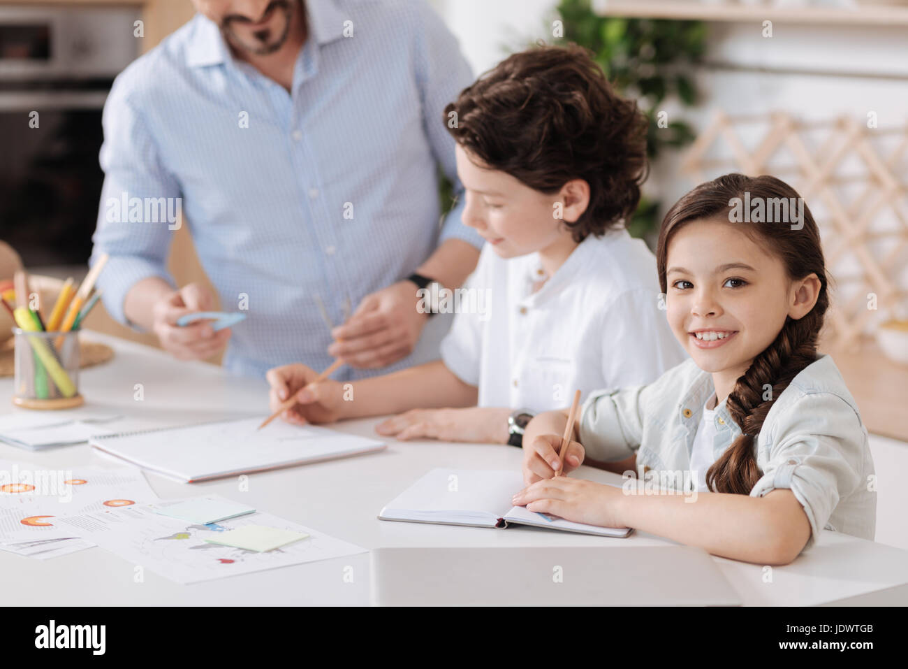 Pretty little girl doing her home assignment Stock Photo - Alamy