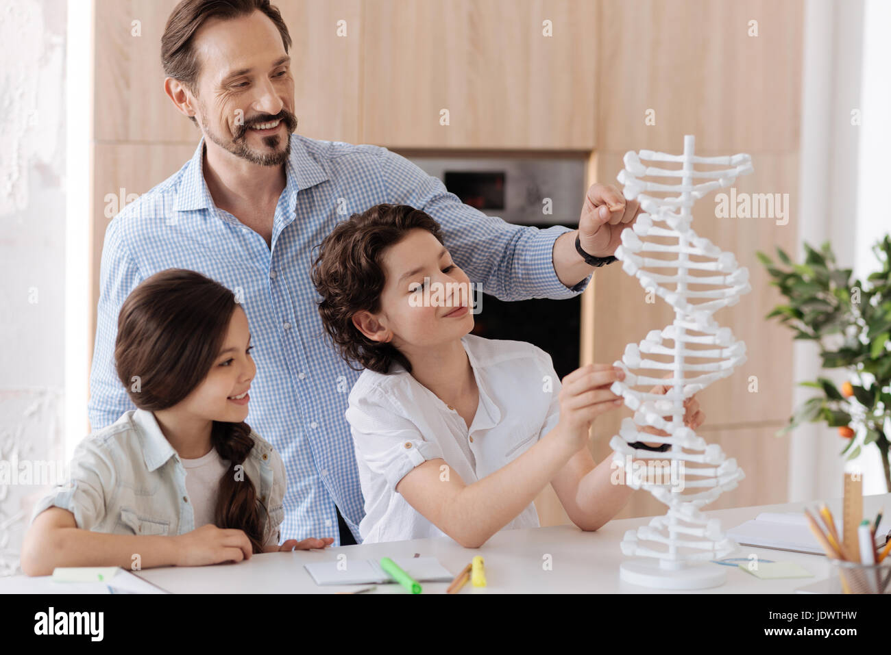 Father and his children studying a 3D DNA model Stock Photo - Alamy