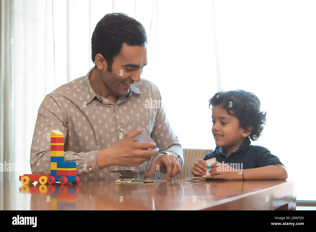 Father and son playing game with cards Stock Photo - Alamy