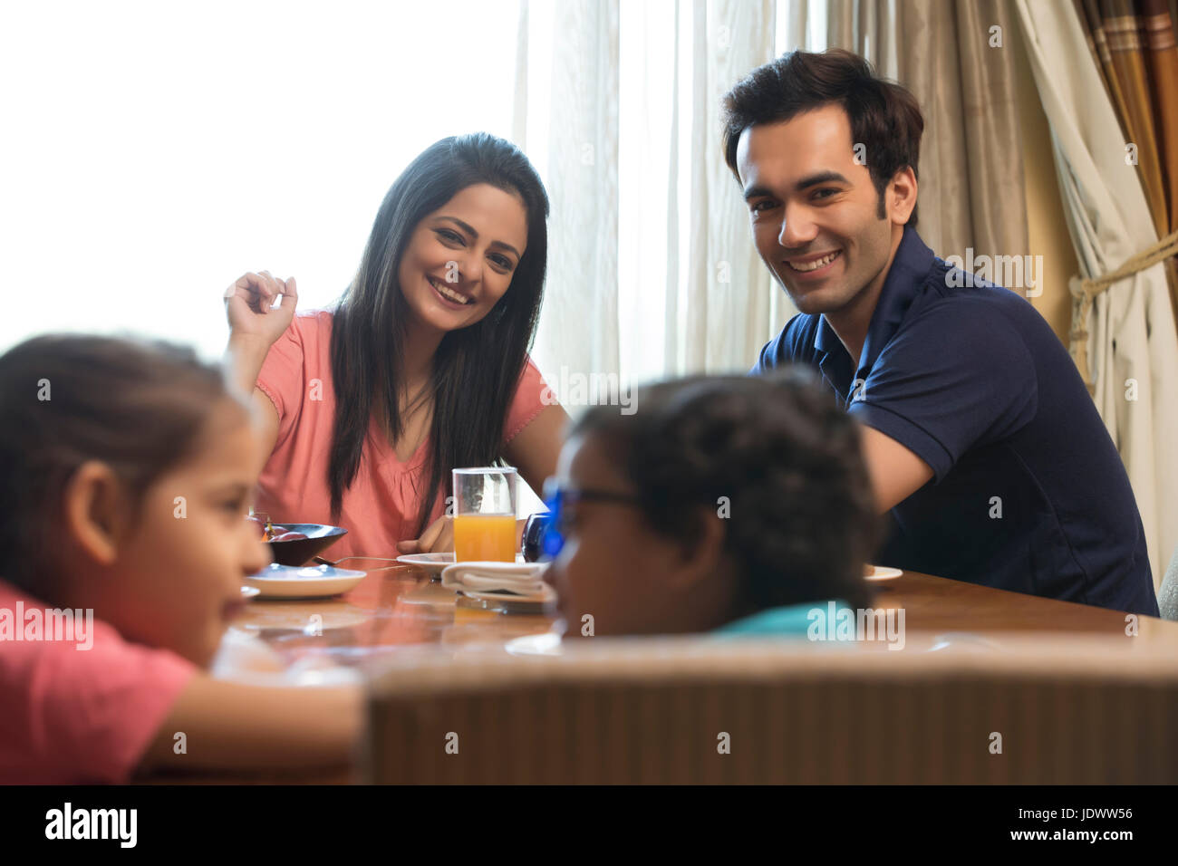 Family eating a meal at the table Stock Photo - Alamy