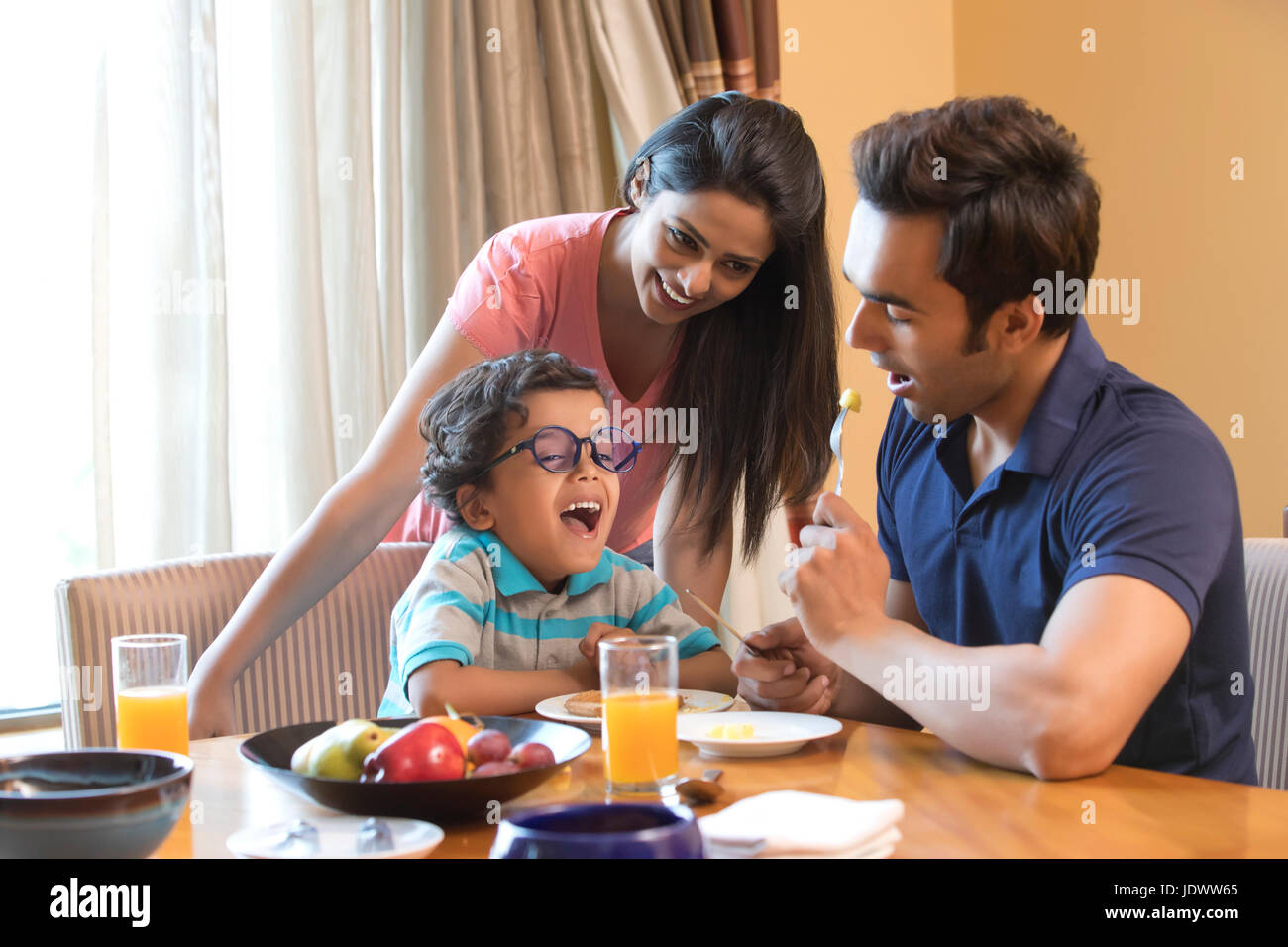 Happy family enjoying meal time Stock Photo - Alamy