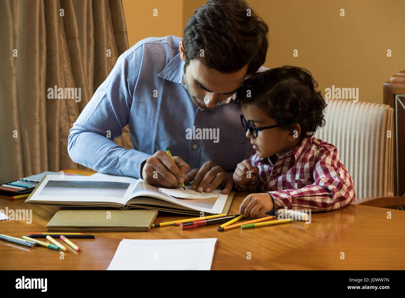 Father helping son with homework Stock Photo - Alamy
