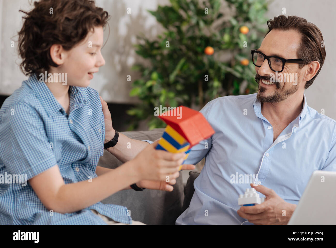 Little boy showing a new toy to his father Stock Photo - Alamy