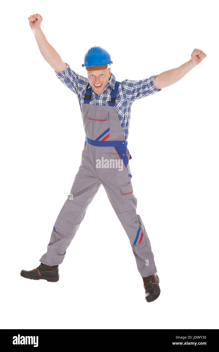 Full length of young manual worker screaming with hands raised over ...