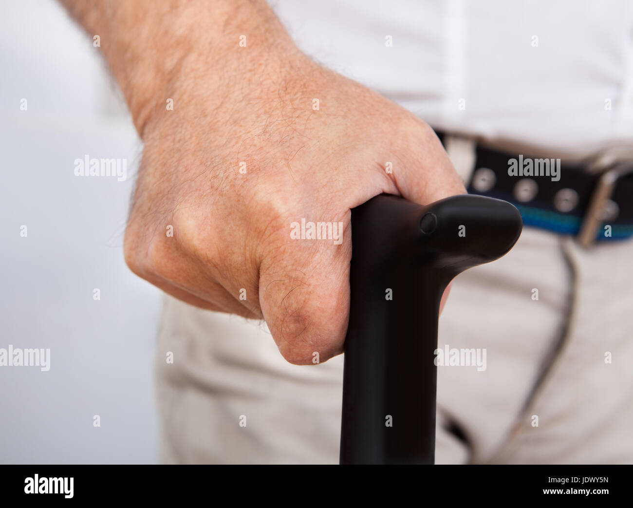 Midsection closeup of disabled senior man with walking stick Stock ...