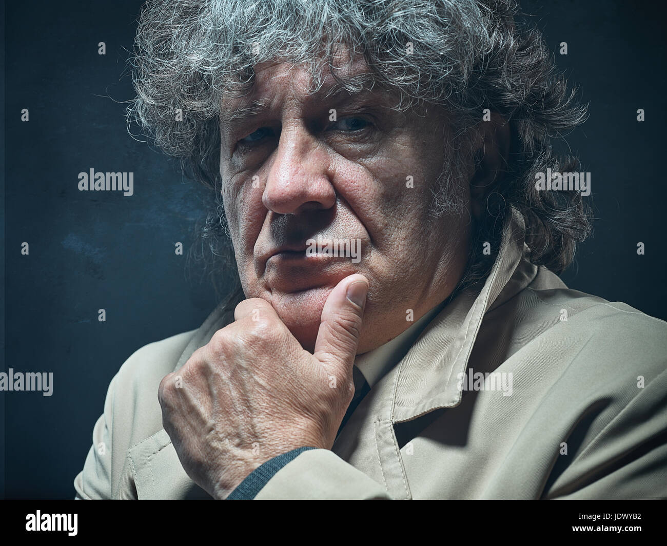 The senior man as detective or boss of mafia on gray studio background ...