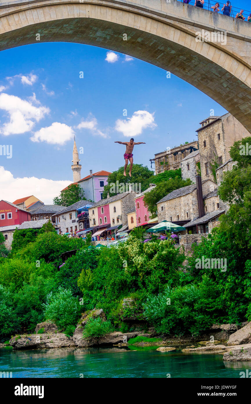 Stari Most Diving. A diver mid air after diving from the Mostar Bridge ...