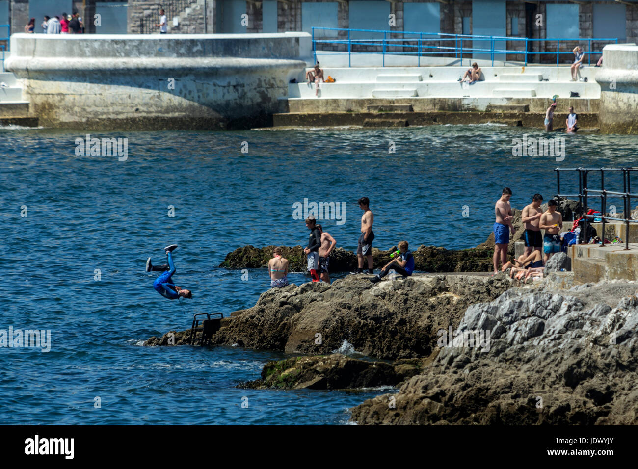 Youths dive and jump into the sea at Plymouth Harbour, Devon, UK Stock ...