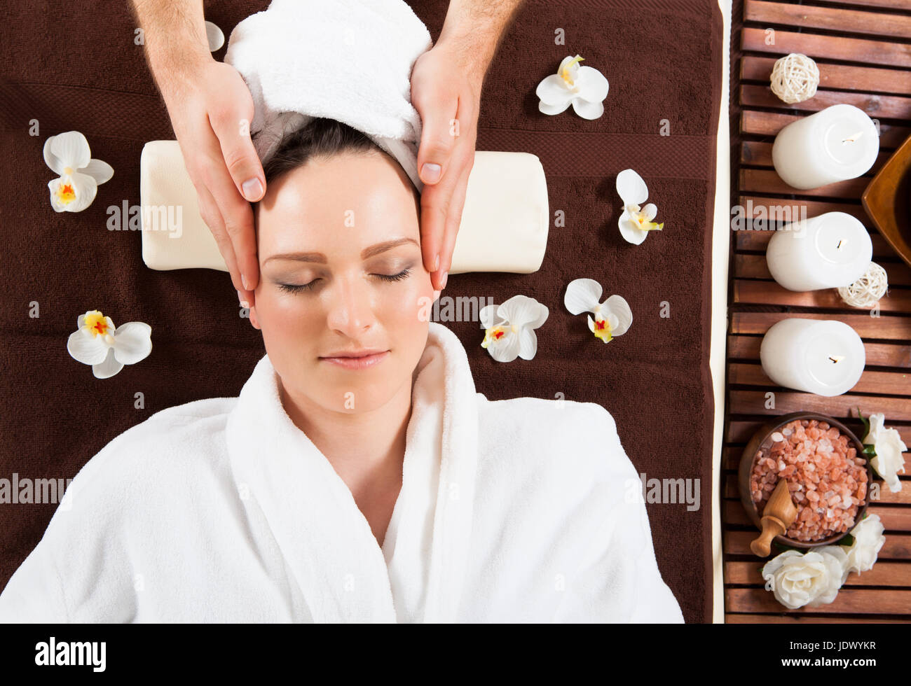 Directly Above Shot Of Young Woman Receiving Head Massage At Beauty Spa