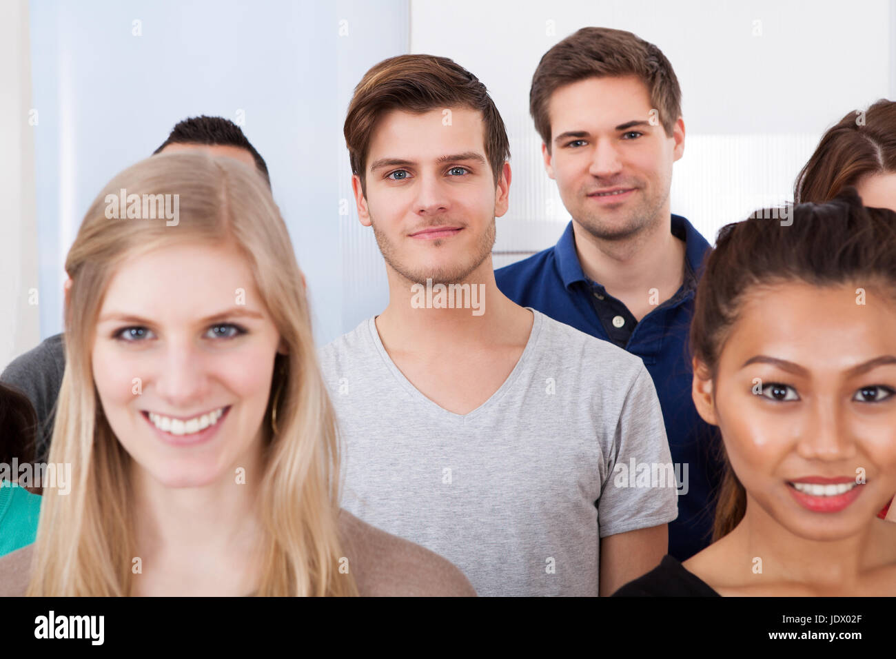 Group portrait of smiling multiethnic college students standing ...