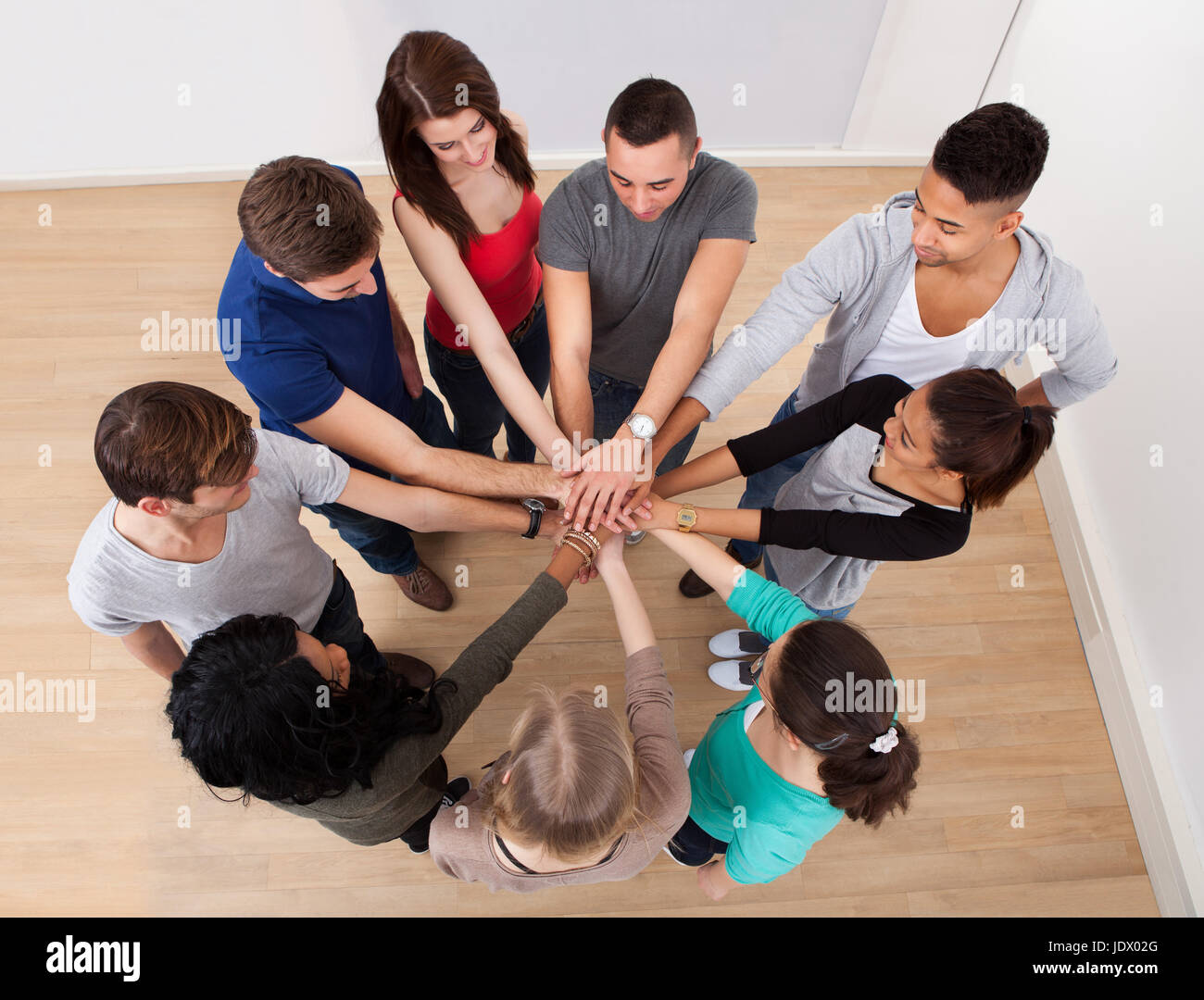 High angle view of multiethnic college students stacking hands in ...