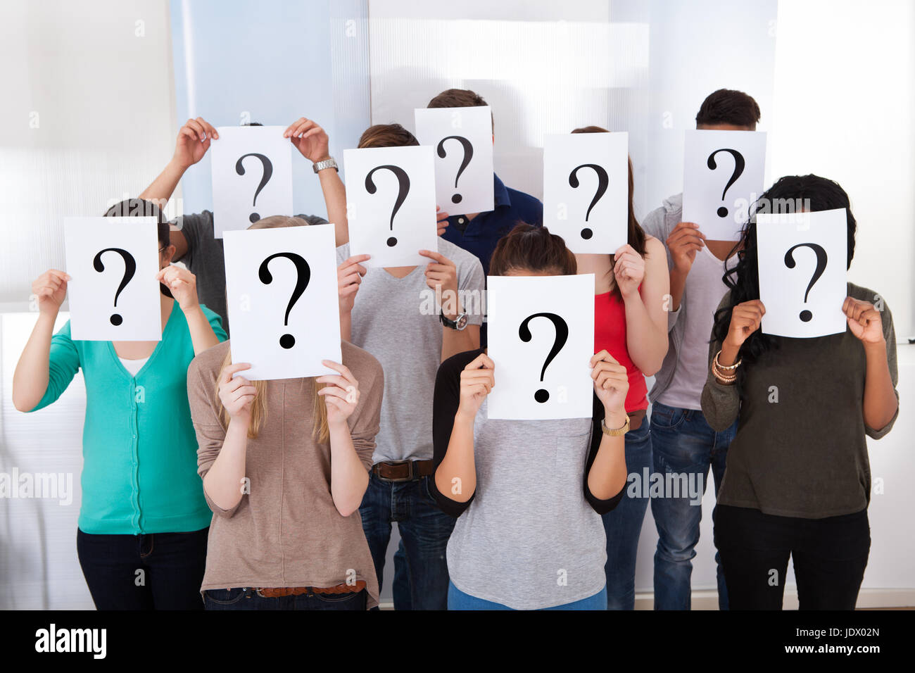 Group multiethnic university students holding question mark signs in ...