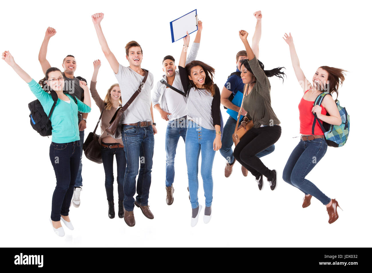 Full length portrait of successful university students with arms raised ...