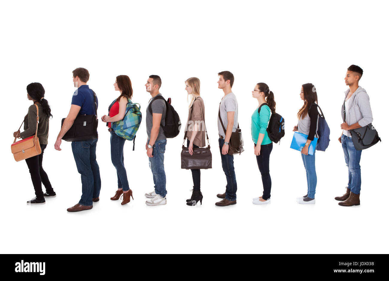 Full length side view of multiethnic college students standing in a row ...