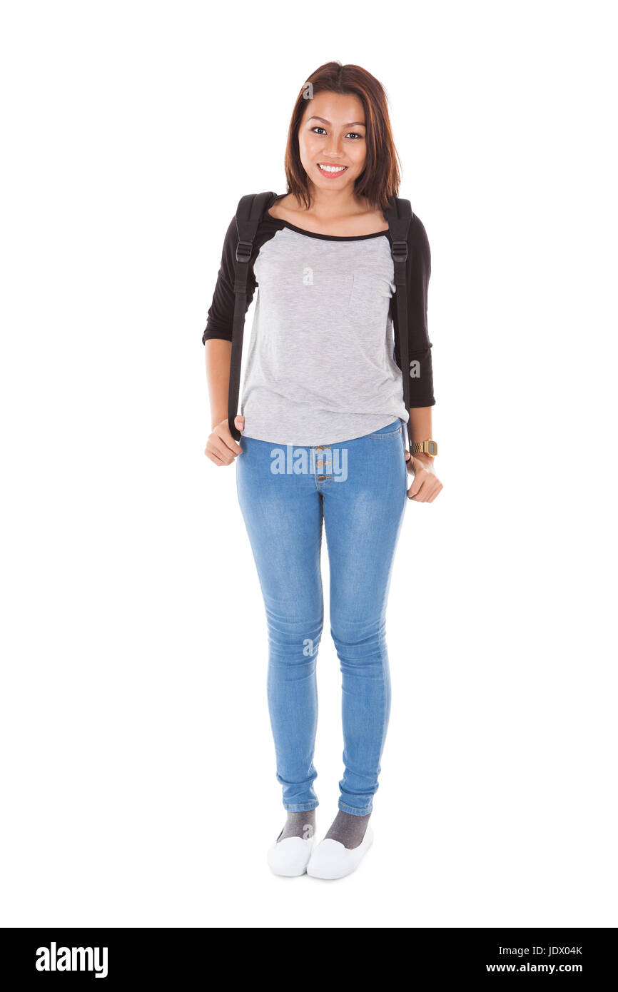 Full length portrait of confident female student standing against white ...