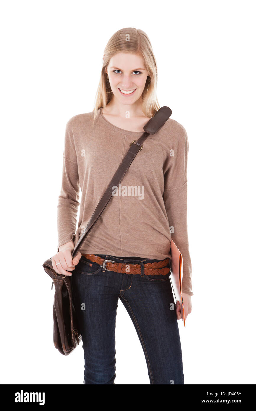 Portrait of confident female student standing against white background ...