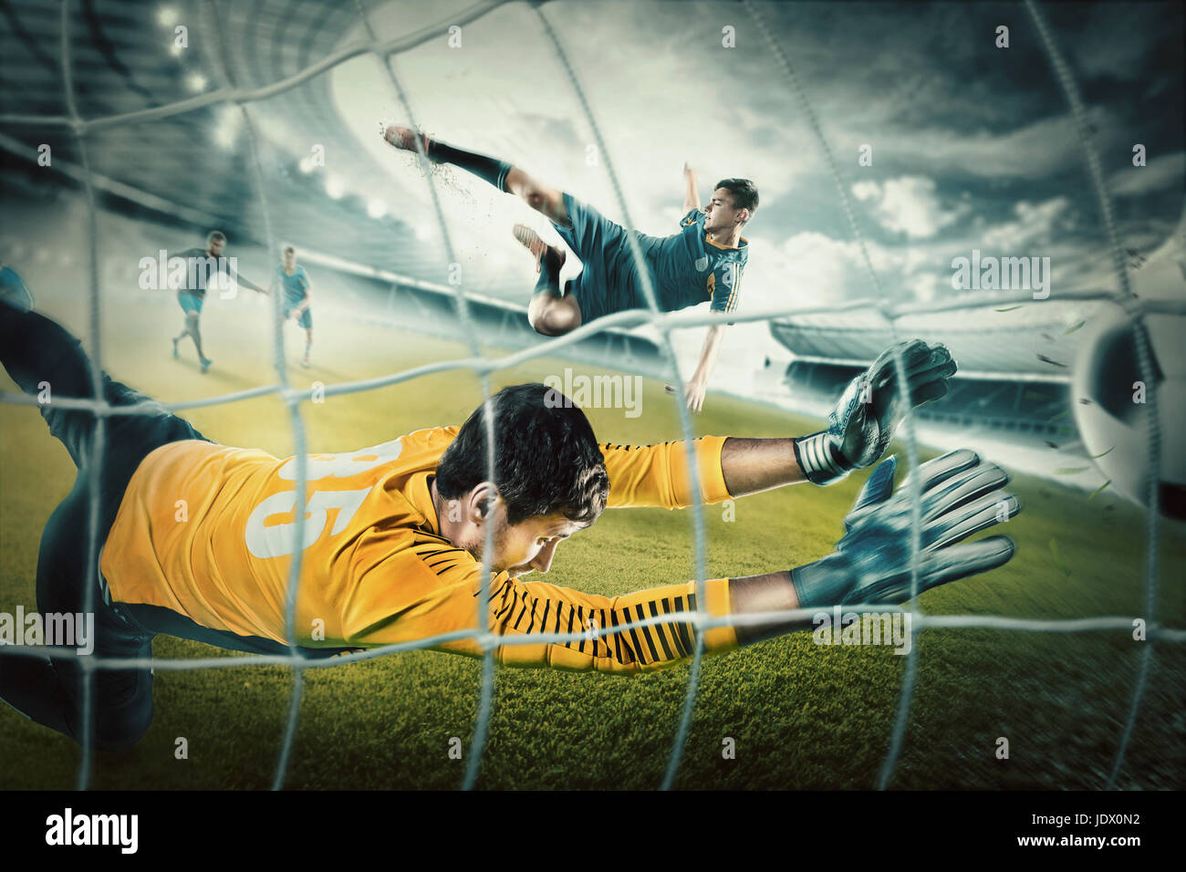 Goalkeeper in gates jumping to catching ball Stock Photo - Alamy