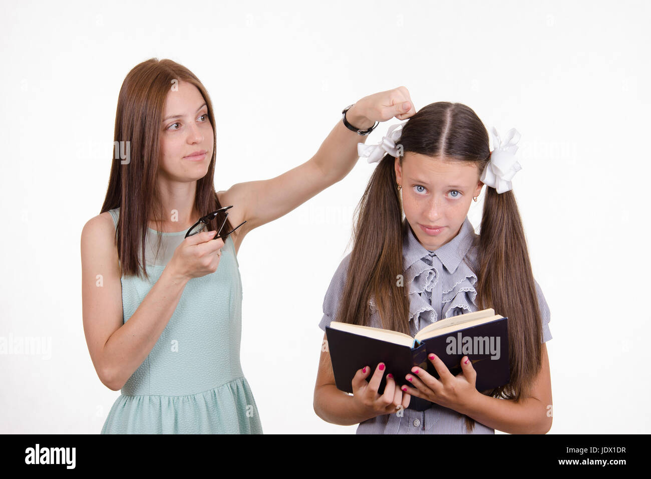 Teacher bangs his hand on the head and scolds student Stock Photo - Alamy